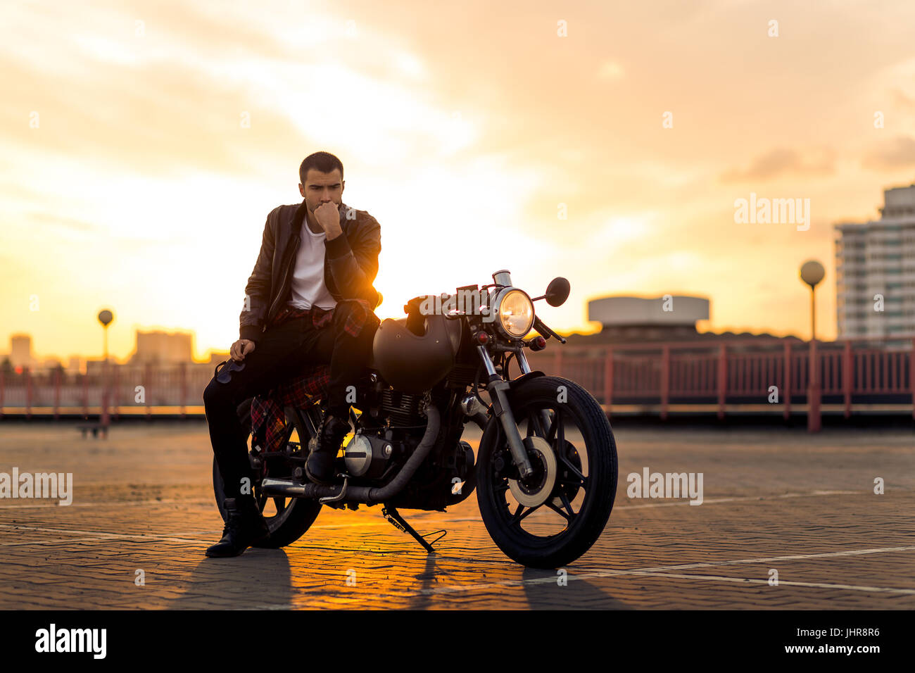 Handsome fit rider guy with beard and mustache in black leather biker ...