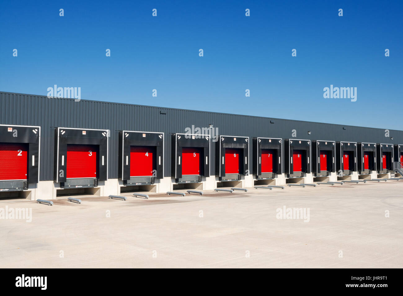 Row of loading docks with shutter doors at a warehouse Stock Photo - Alamy