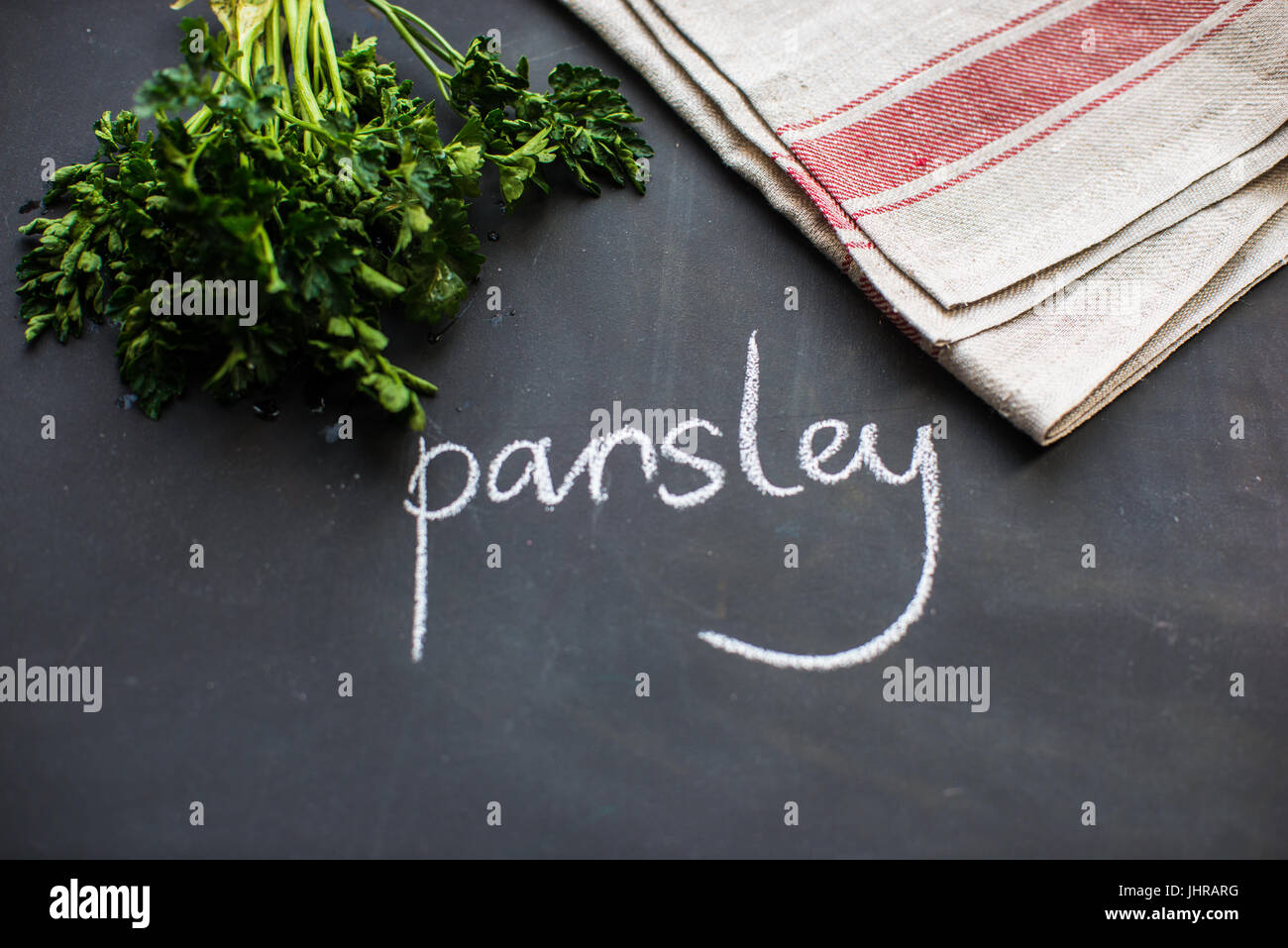 Fresh parsey herb on dark background with copyspace Stock Photo - Alamy