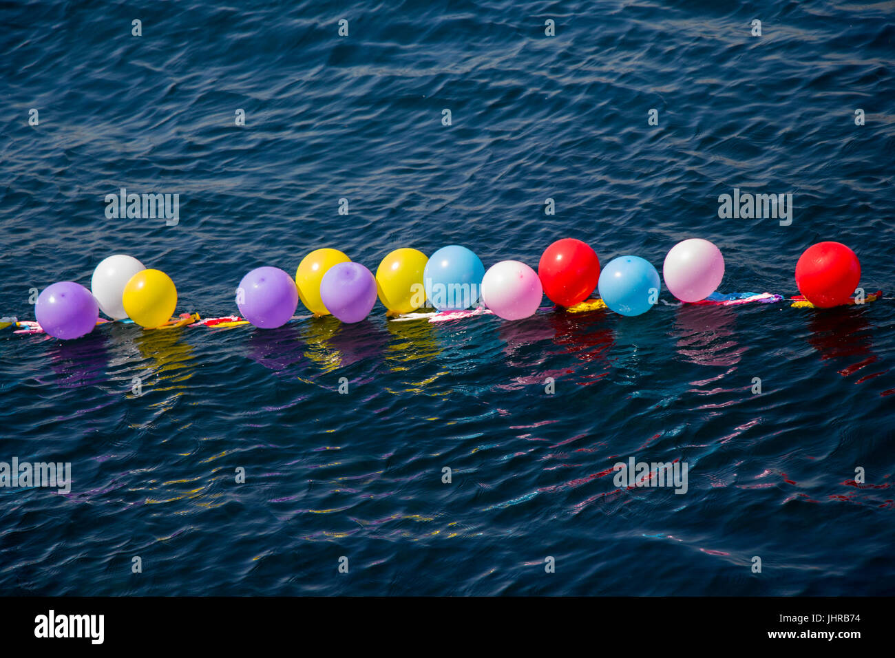 Balloons in shooting range as targets on water Stock Photo - Alamy