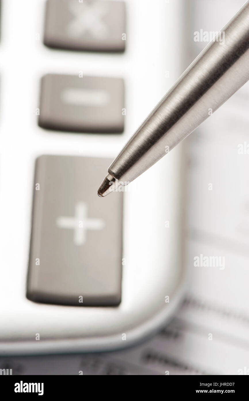 Pen and calculator Stock Photo - Alamy