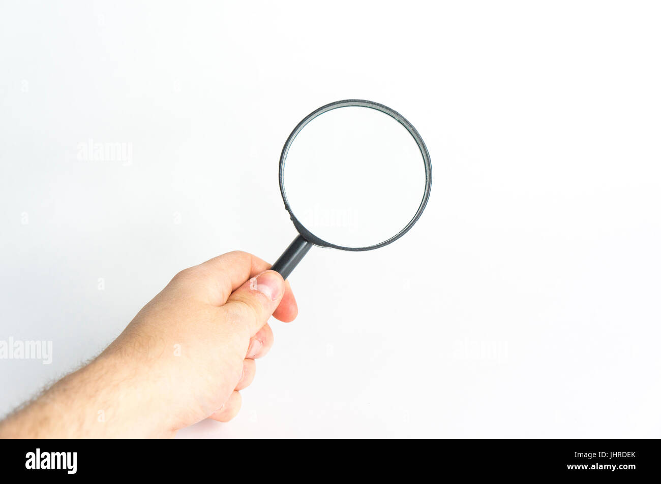 Hand holding magnifying glass on white background, Looking for ...