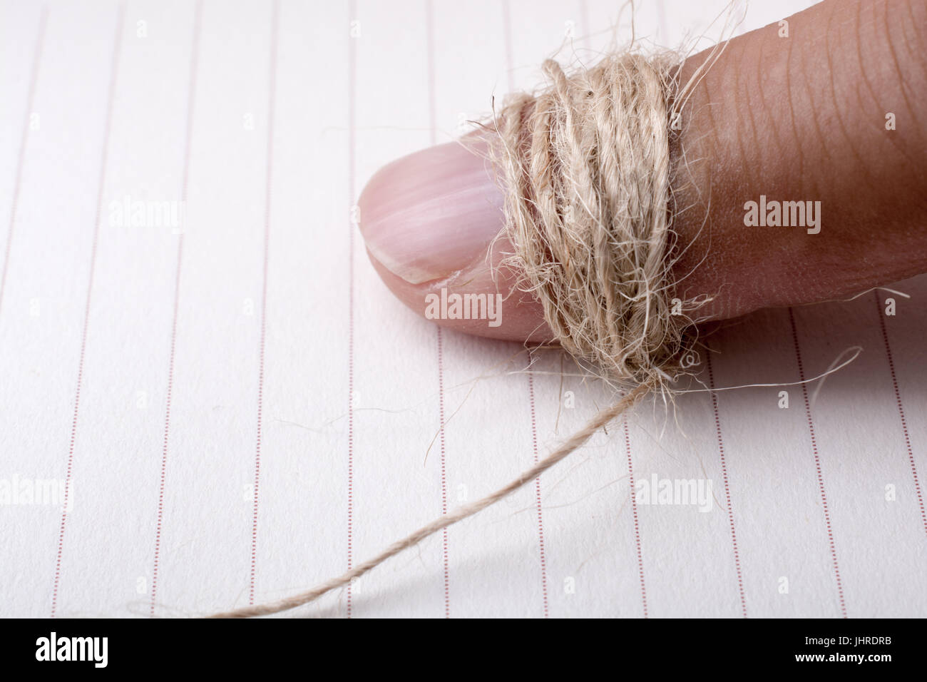 Roll of brown color linen string around finger Stock Photo - Alamy