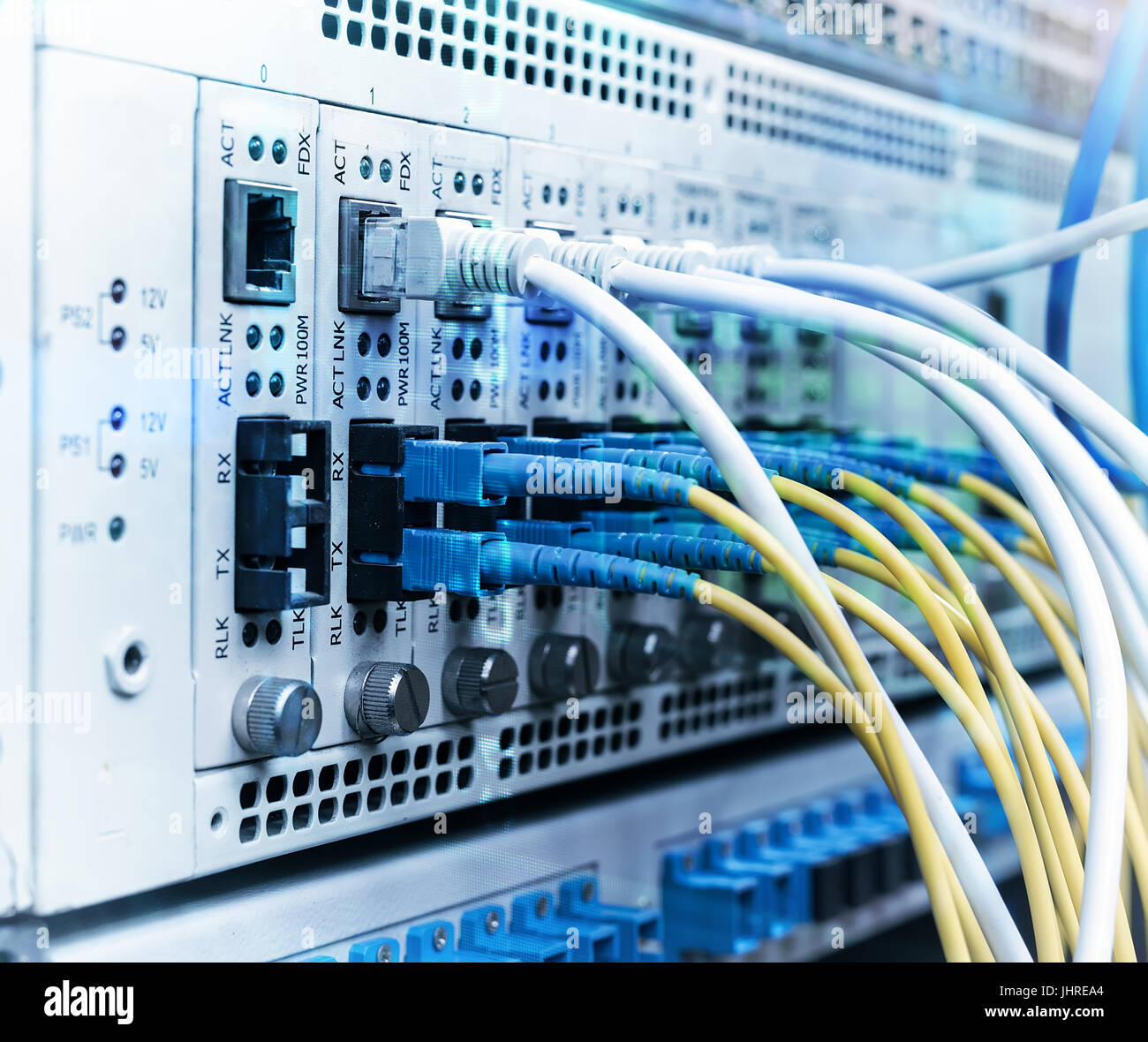 Fiber Optic cables connected to an optic ports and Network cables ...