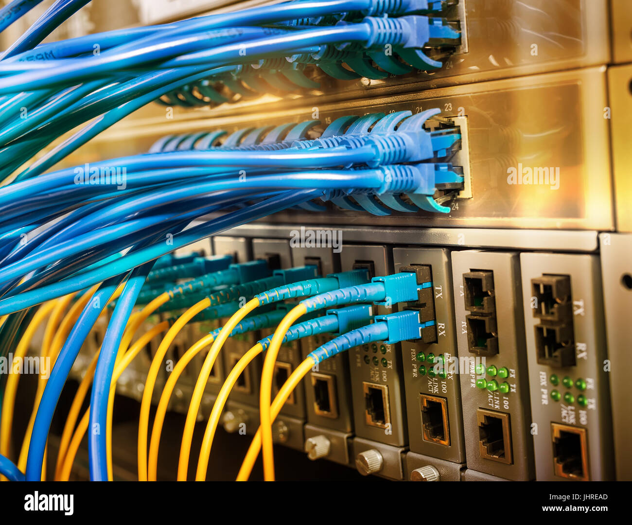 Fiber Optic cables connected to an optic ports and Network cables ...