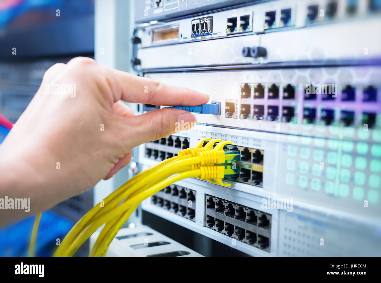 hand with network cables connected to servers in a datacenter Stock ...