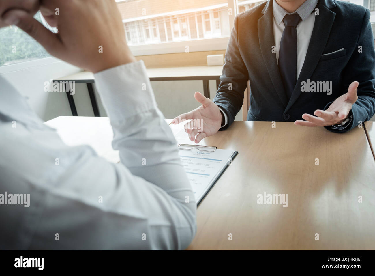 Business - young man explaining about his profile to business managers ...