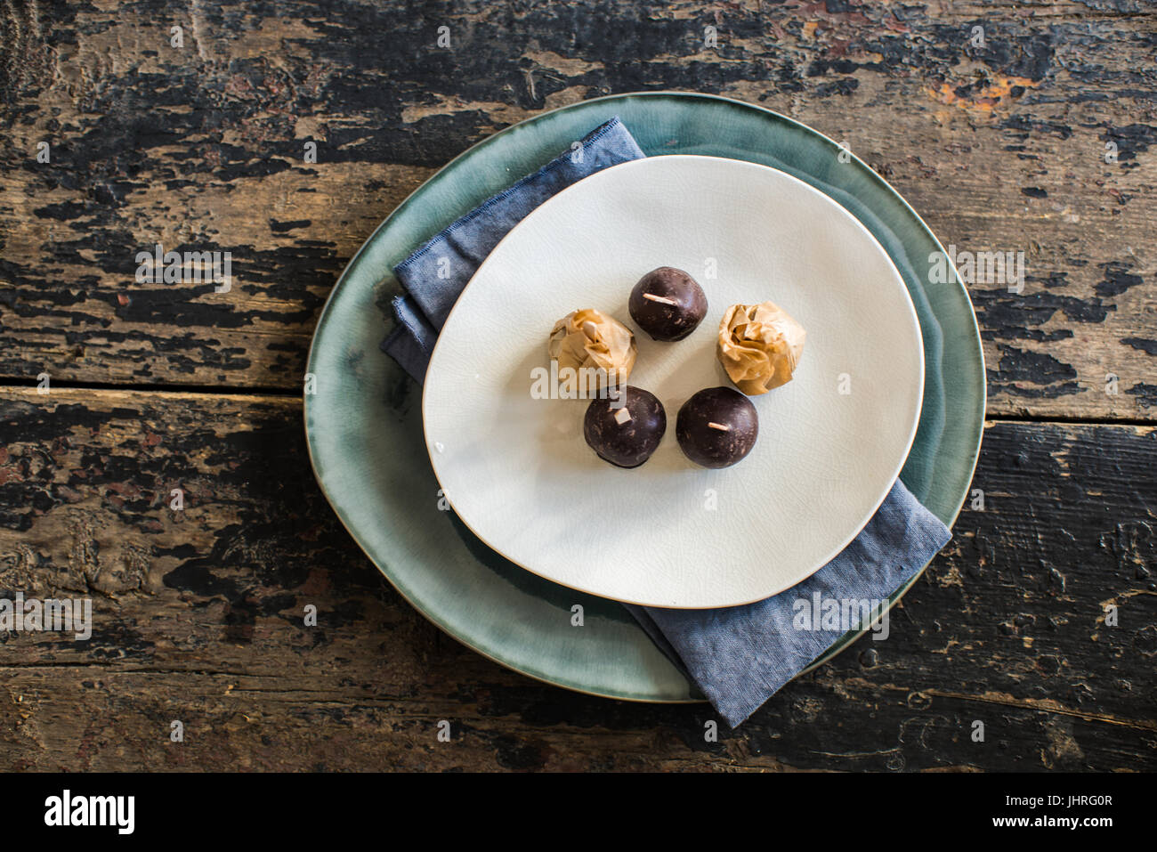 Homemade candies - fruits in chocolate on rustic plates Stock Photo - Alamy