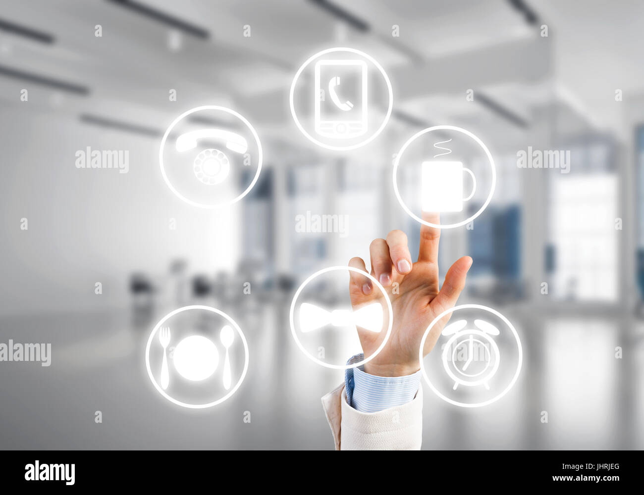 Modern office interior and close of businesswoman hand choosing symbol ...
