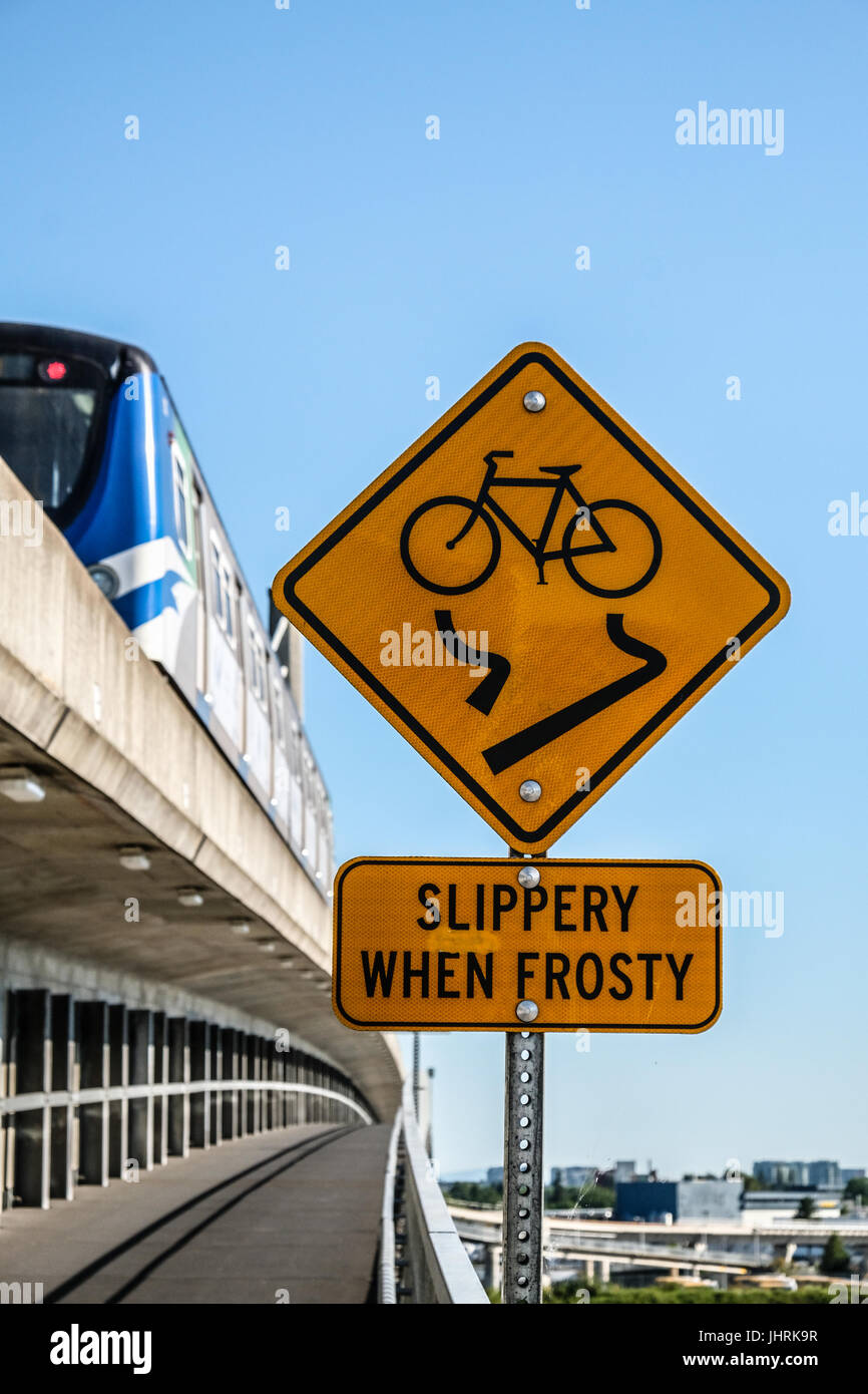 A Slippery When Frosty sign and a skytrain on North Arm Canada Line ...