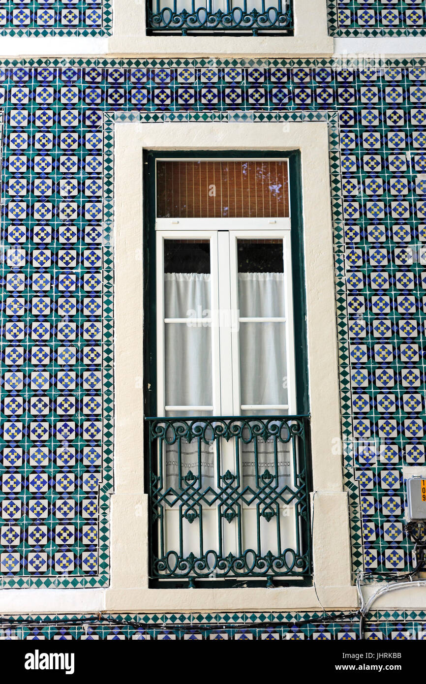 Blue tile facade with window and iron balcony typical architectu hi-res ...