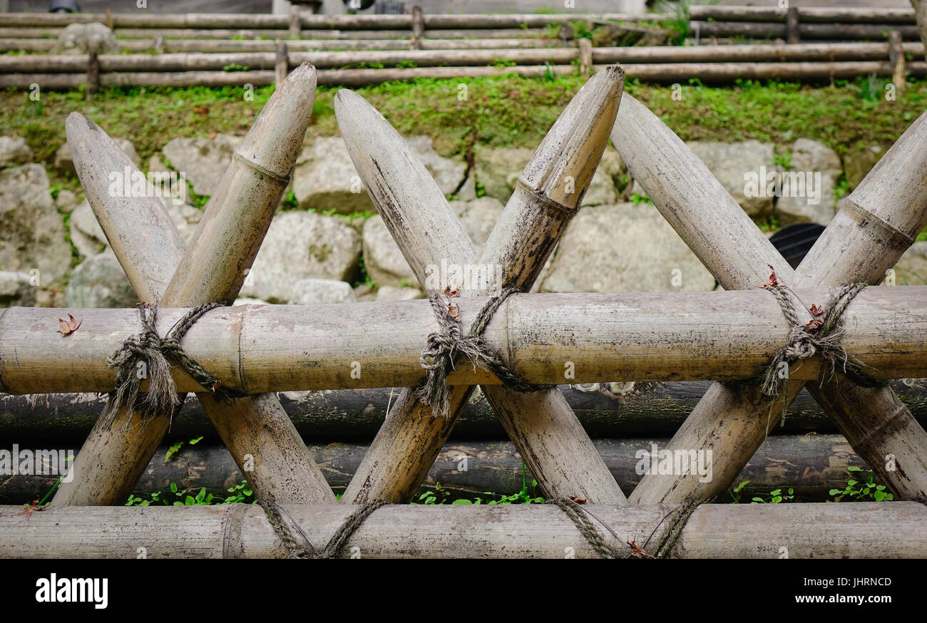 Closeup of Japanese wooden fence at sunny day in the Buddhist temple ...