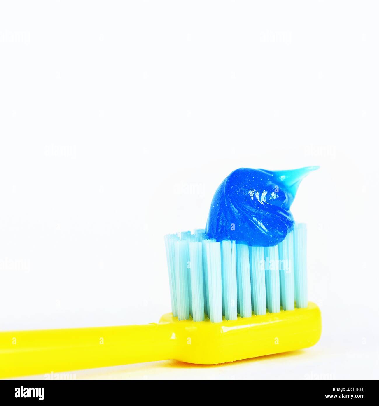 Toothbrush with paste on a white background Stock Photo - Alamy