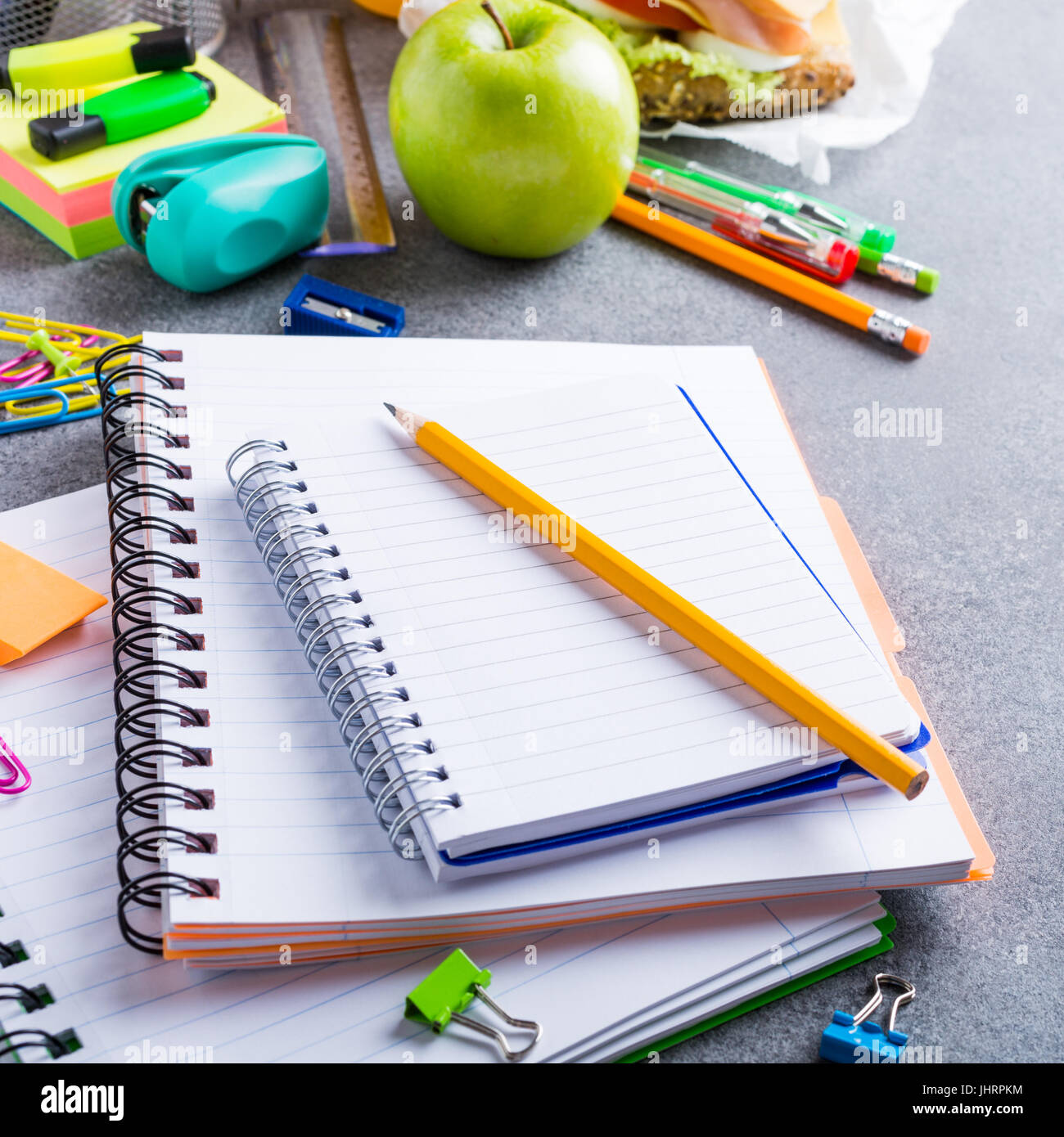 Assorted colorful school supplies on gray stone background. Concept ...