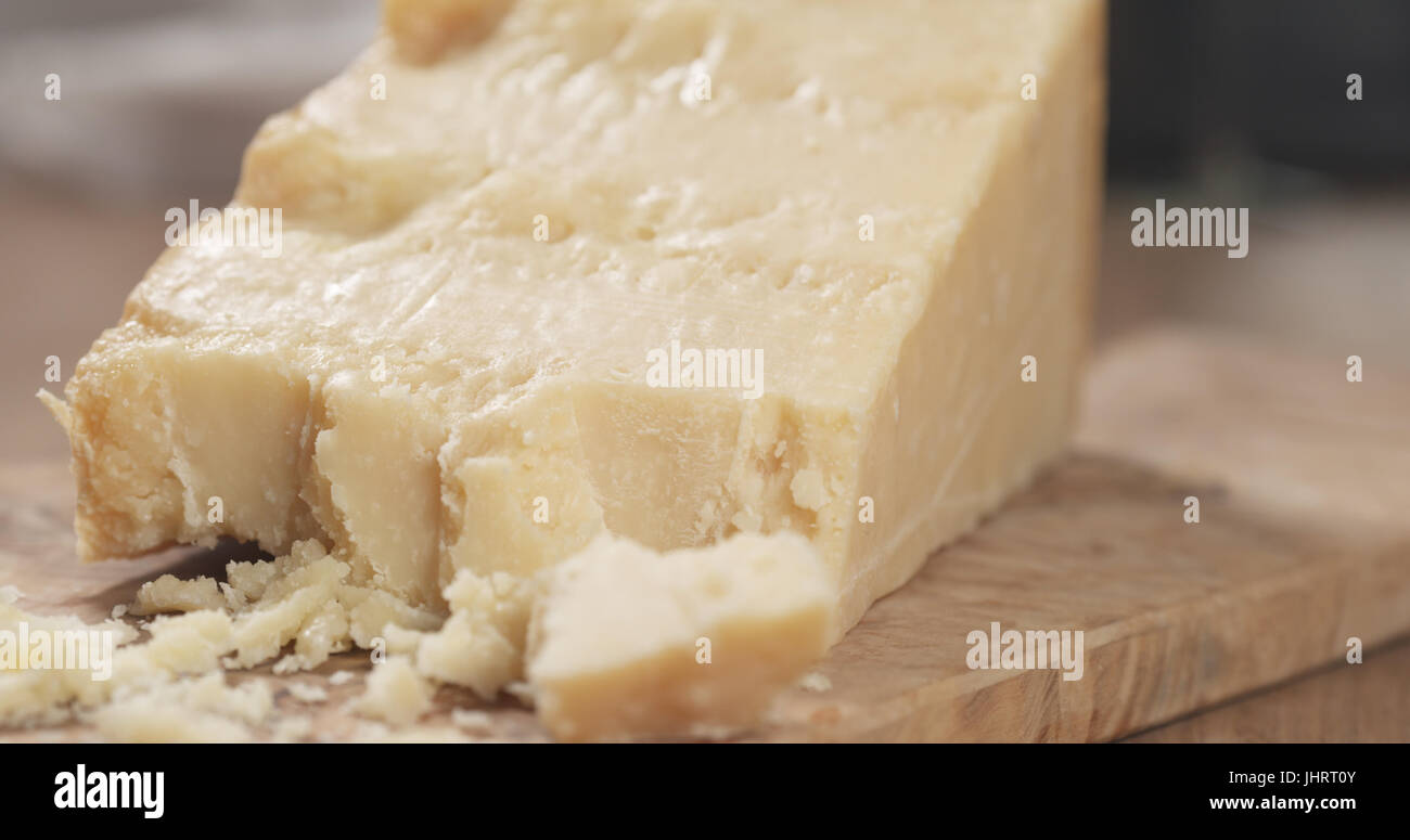 pieces of hard parmesan cheese on olive board Stock Photo - Alamy
