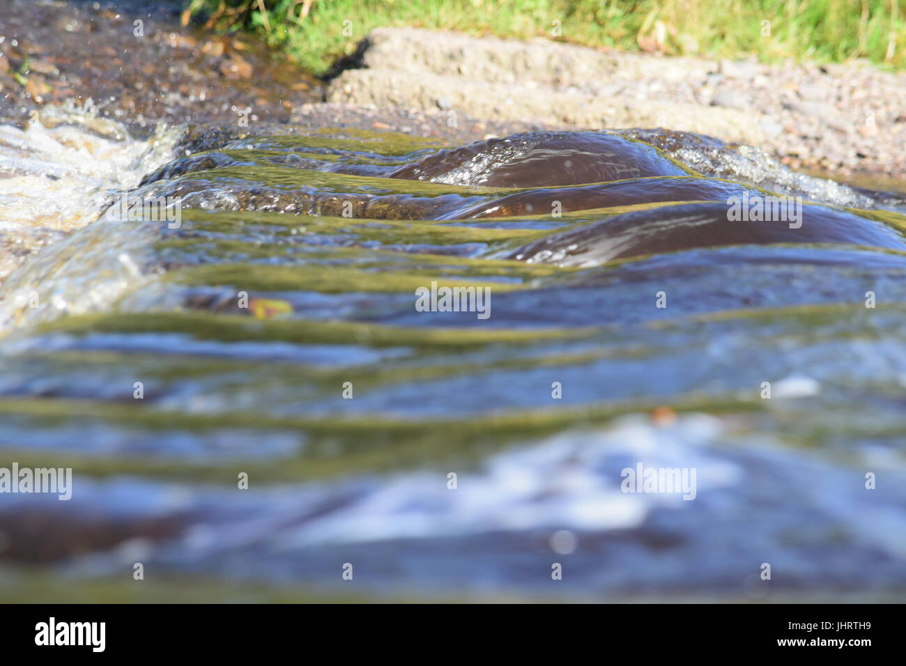 Water over a weir Stock Photo - Alamy
