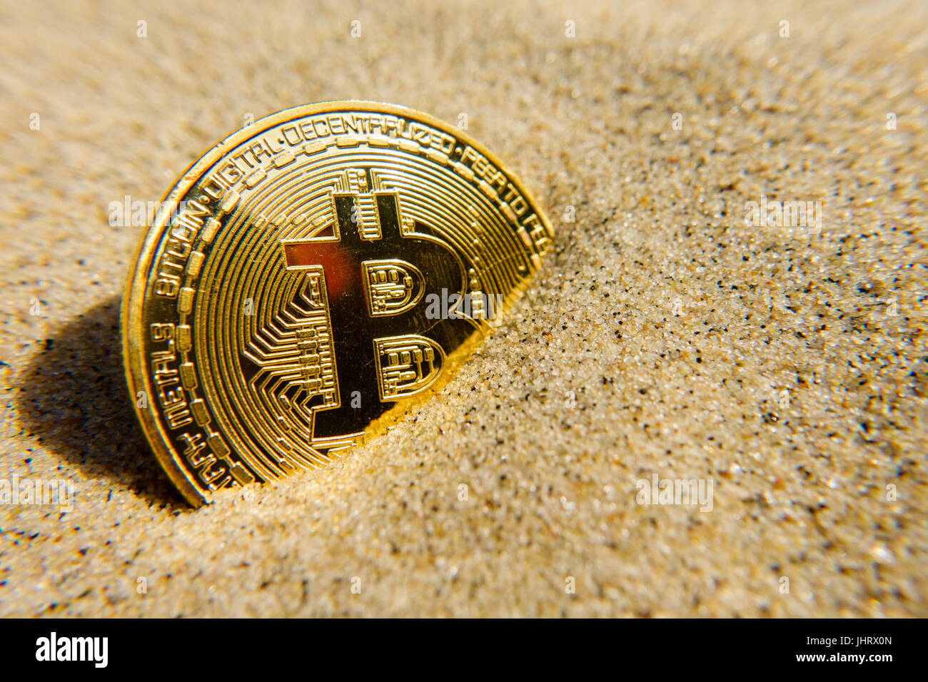 Bitcoin btc coin in sand hi-res stock photography and images - Alamy