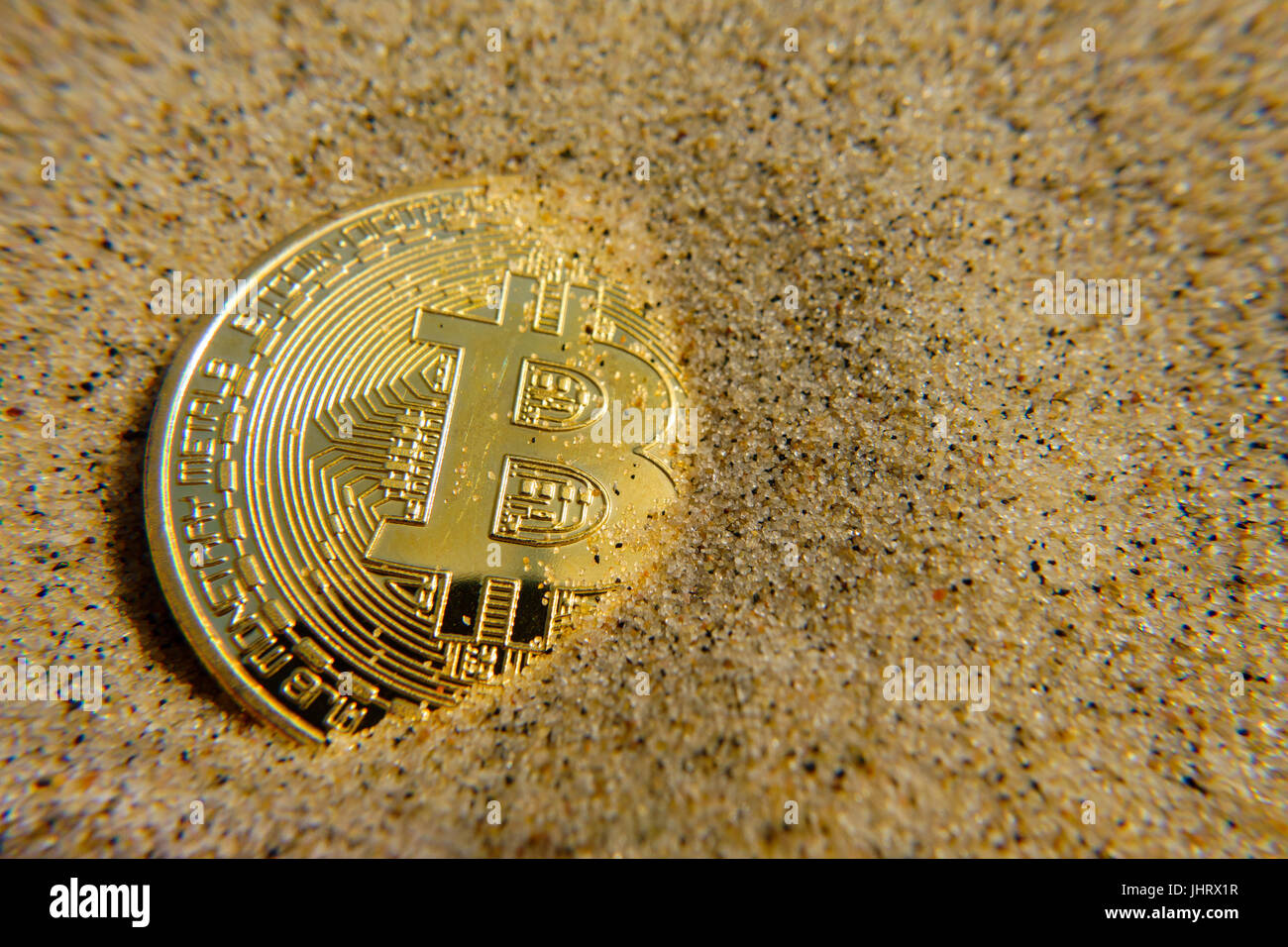 Bitcoin btc coin in sand hi-res stock photography and images - Alamy
