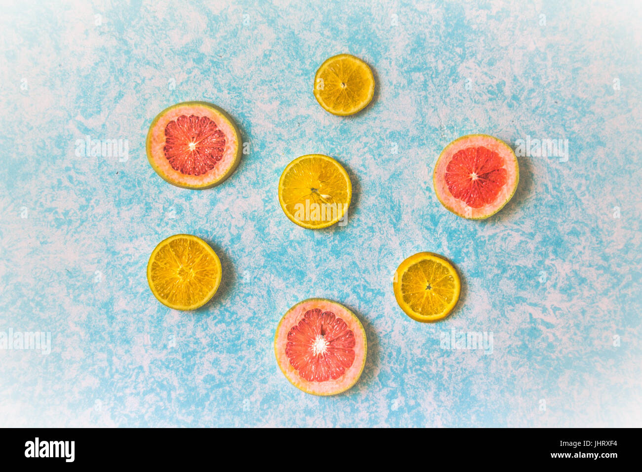 Photograph of some grapefruit slices on light blue background Stock ...
