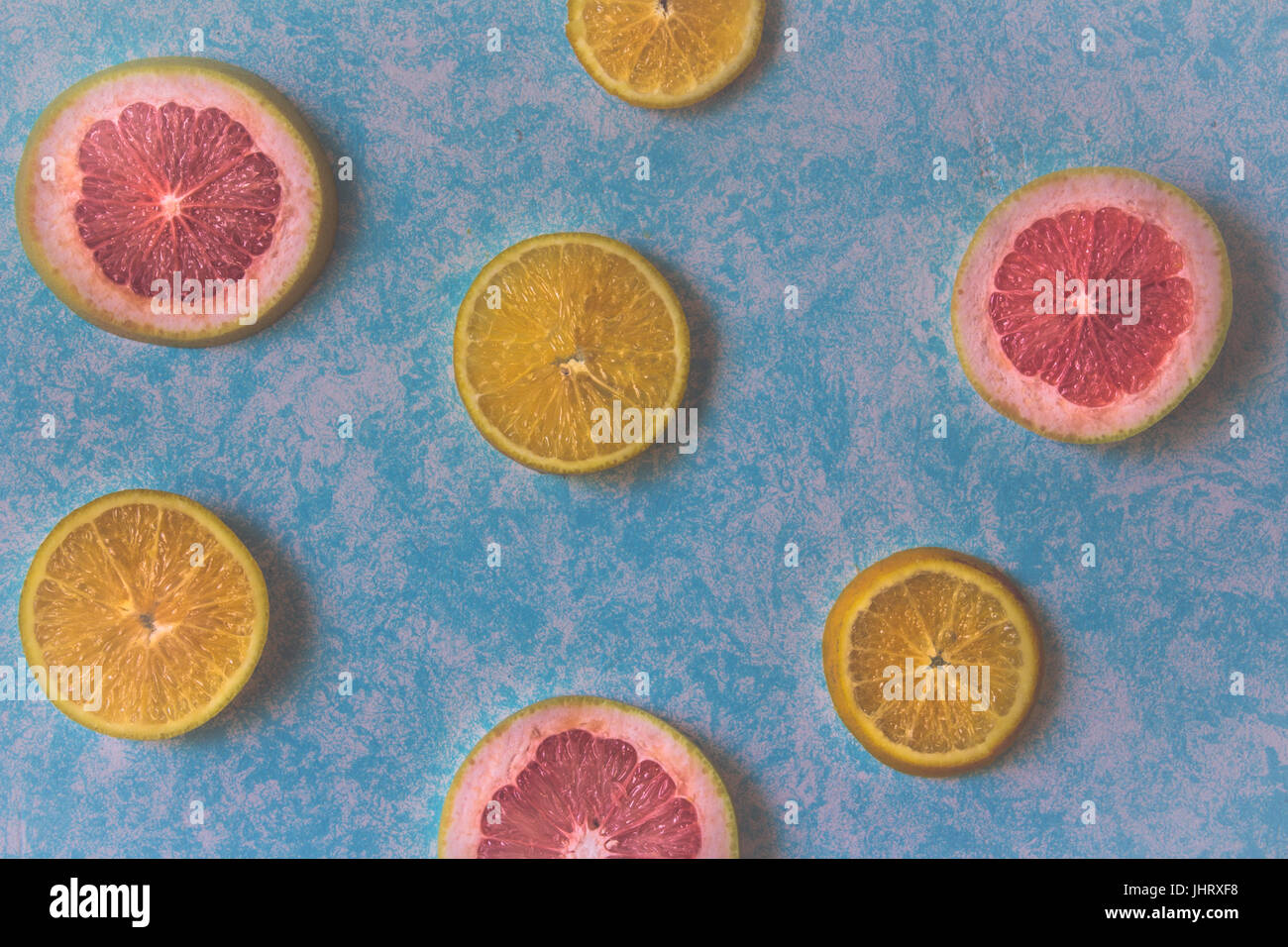 Photograph of some grapefruit slices on light blue background Stock ...