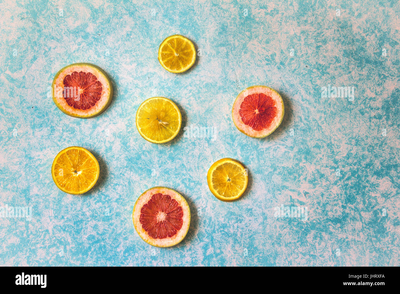 Photograph of some grapefruit slices on light blue background Stock ...