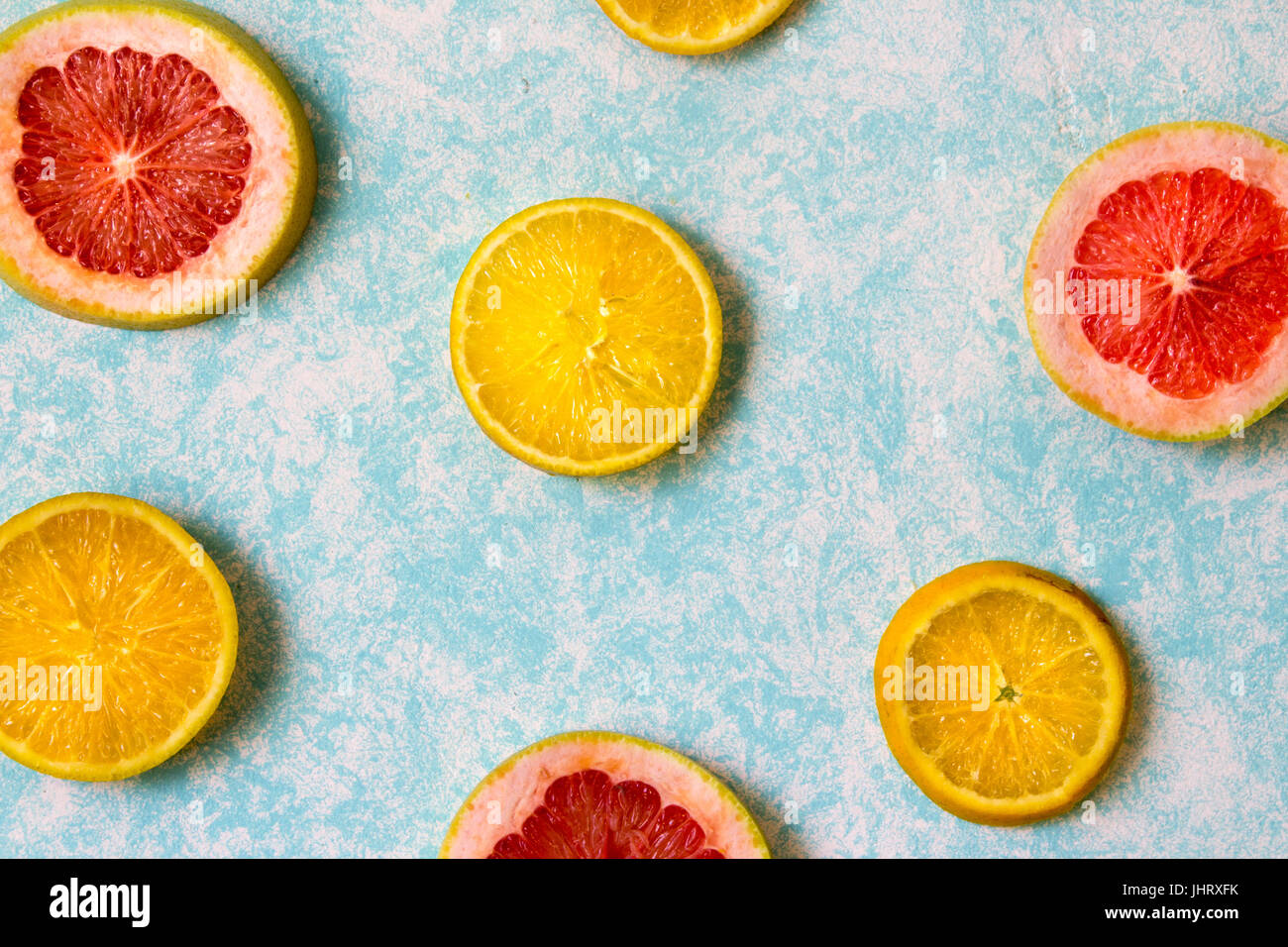 Photograph of some grapefruit slices on light blue background Stock ...