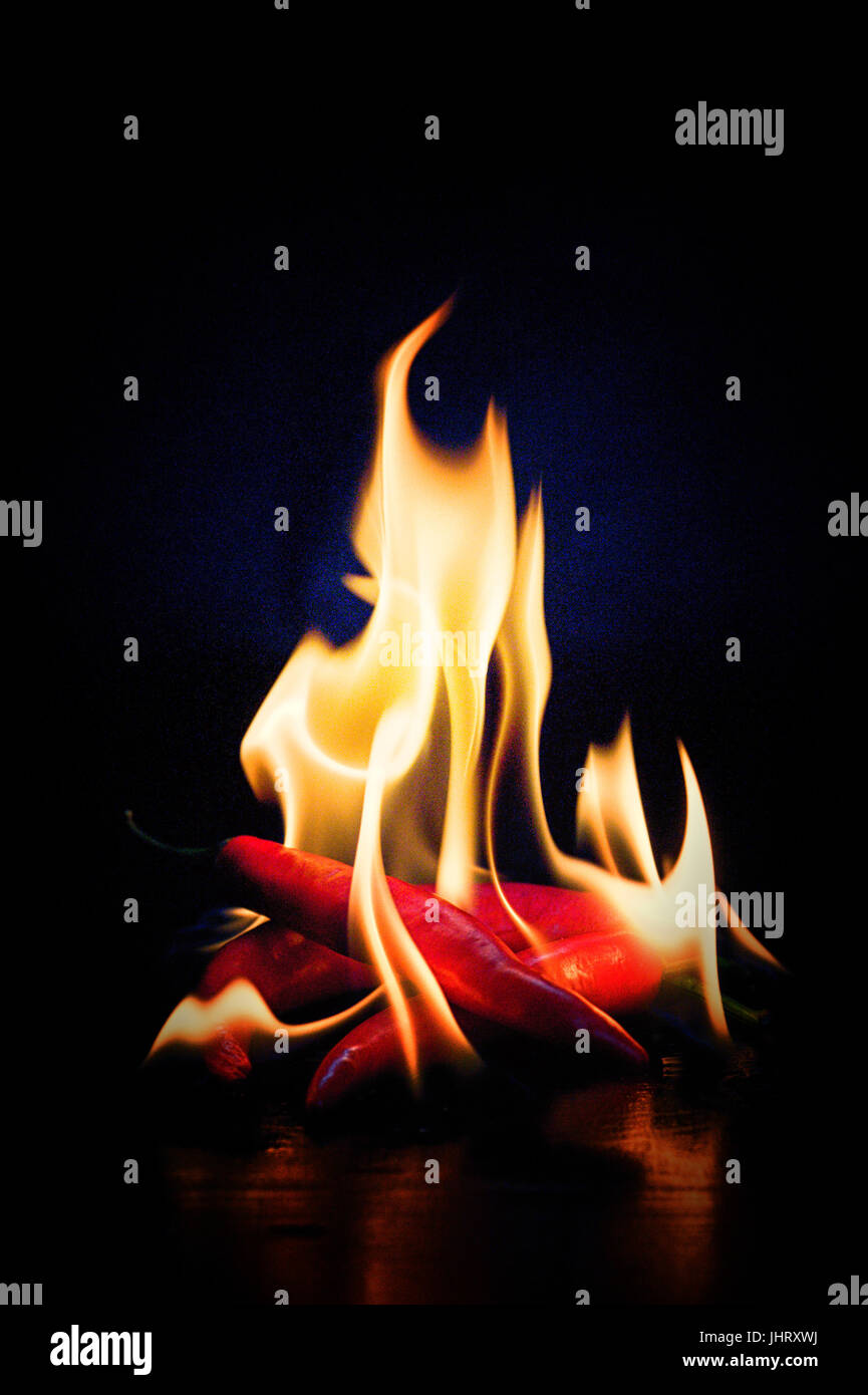 Chilli peppers roasting in a flame Stock Photo - Alamy