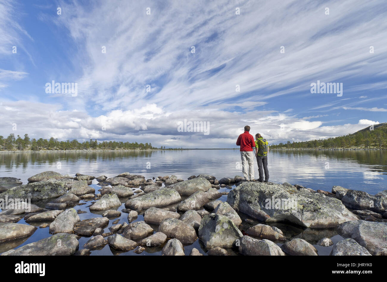 Pair looks over the lake roe, natural reserve roe, Haerjedalen, Sweden ...