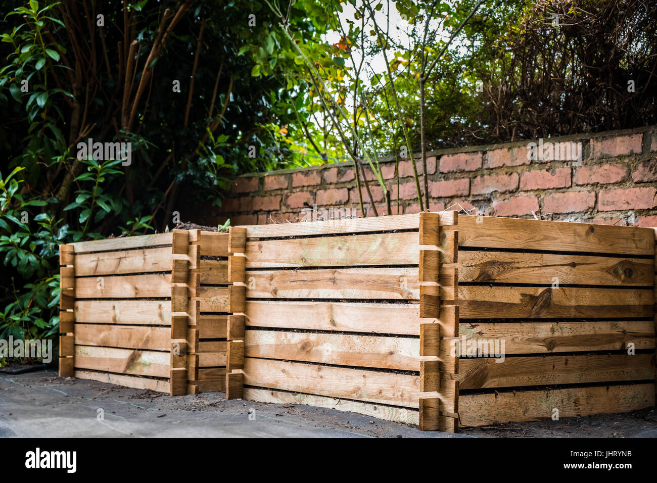 Two wooden compost bins in a back garden Stock Photo - Alamy
