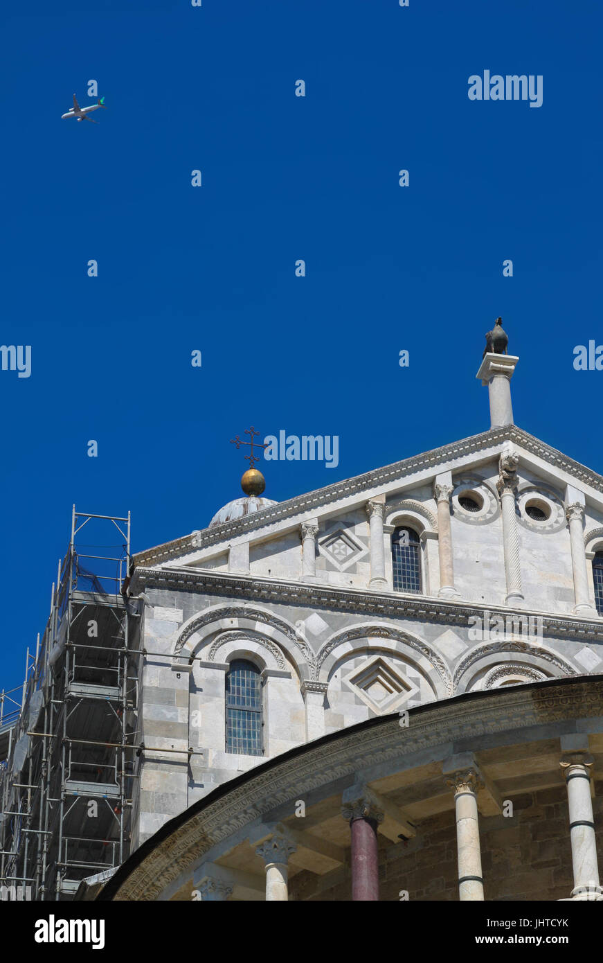Detail of roof top of cathedral in Pisa, Italy with touristic plane on ...