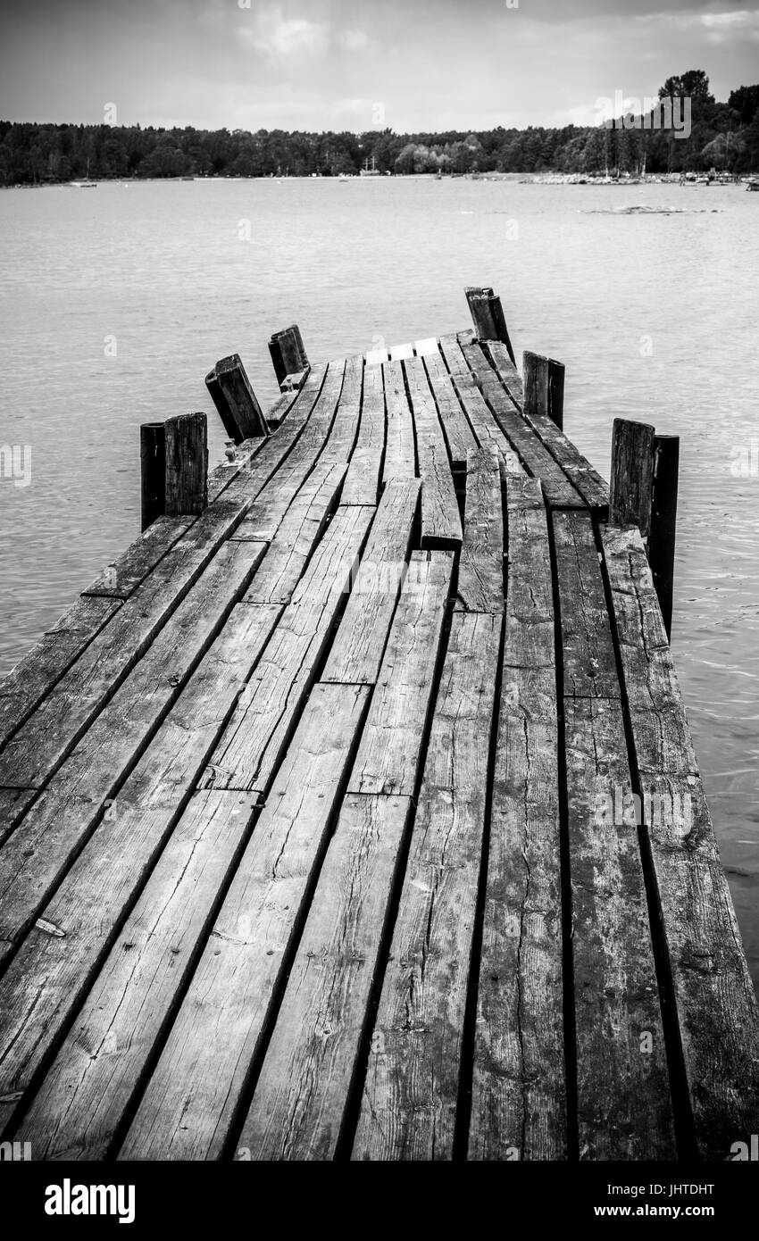 Old long and worn wooden foot bridge in water Stock Photo - Alamy