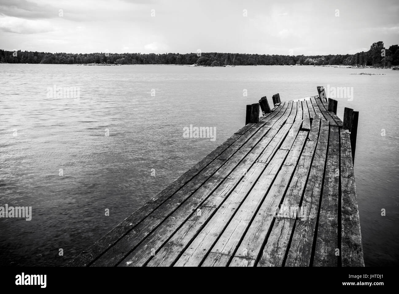 Old long and worn wooden foot bridge in water Stock Photo - Alamy