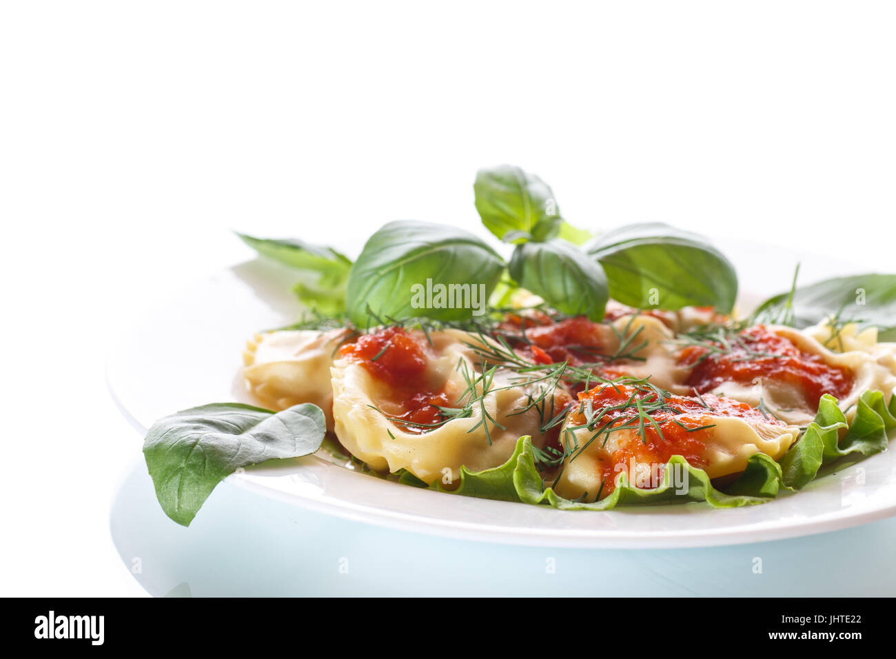 Ravioli with tomato sauce on a white background Stock Photo - Alamy