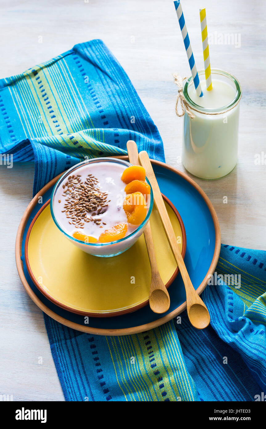 Healthy breakast corn flakes in a bowl and glass of milk on rustic ...