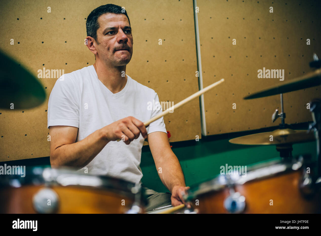 Behind the scene. Male drummer artist musician playing the drums with ...