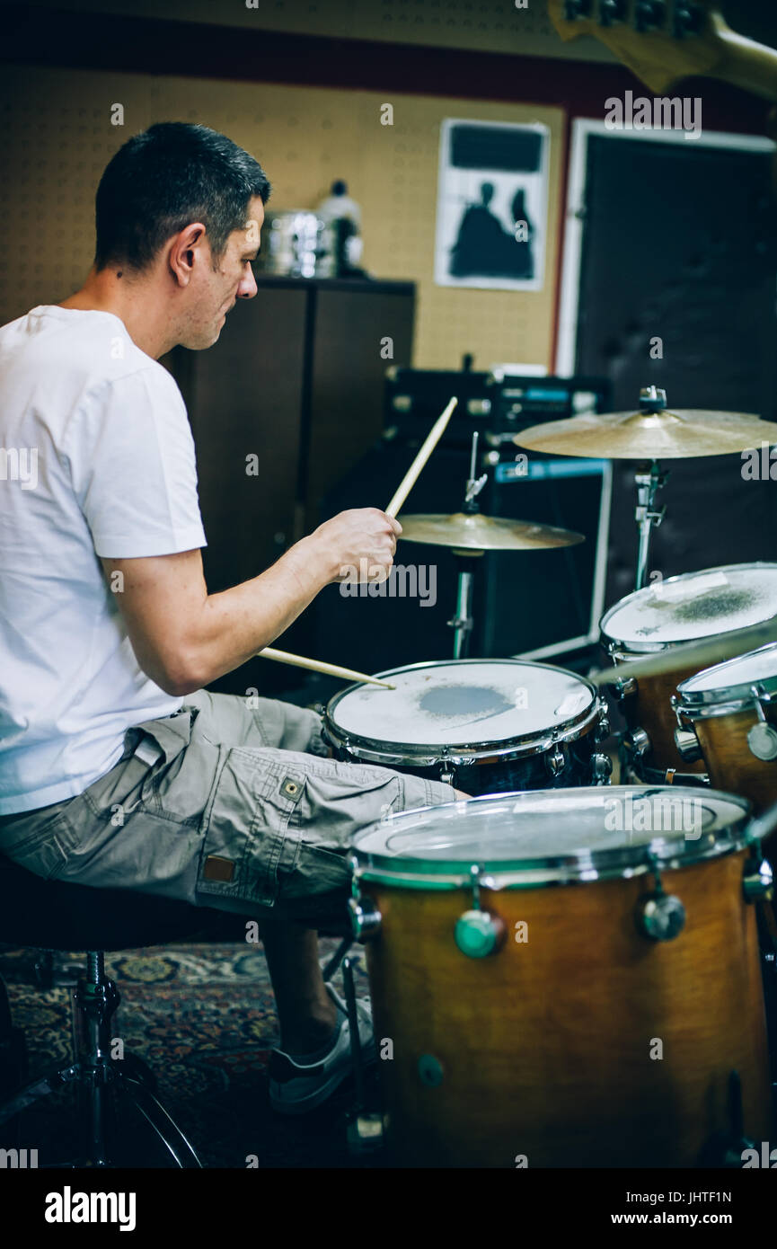 Behind the scene. Male drummer artist musician playing the drums with ...