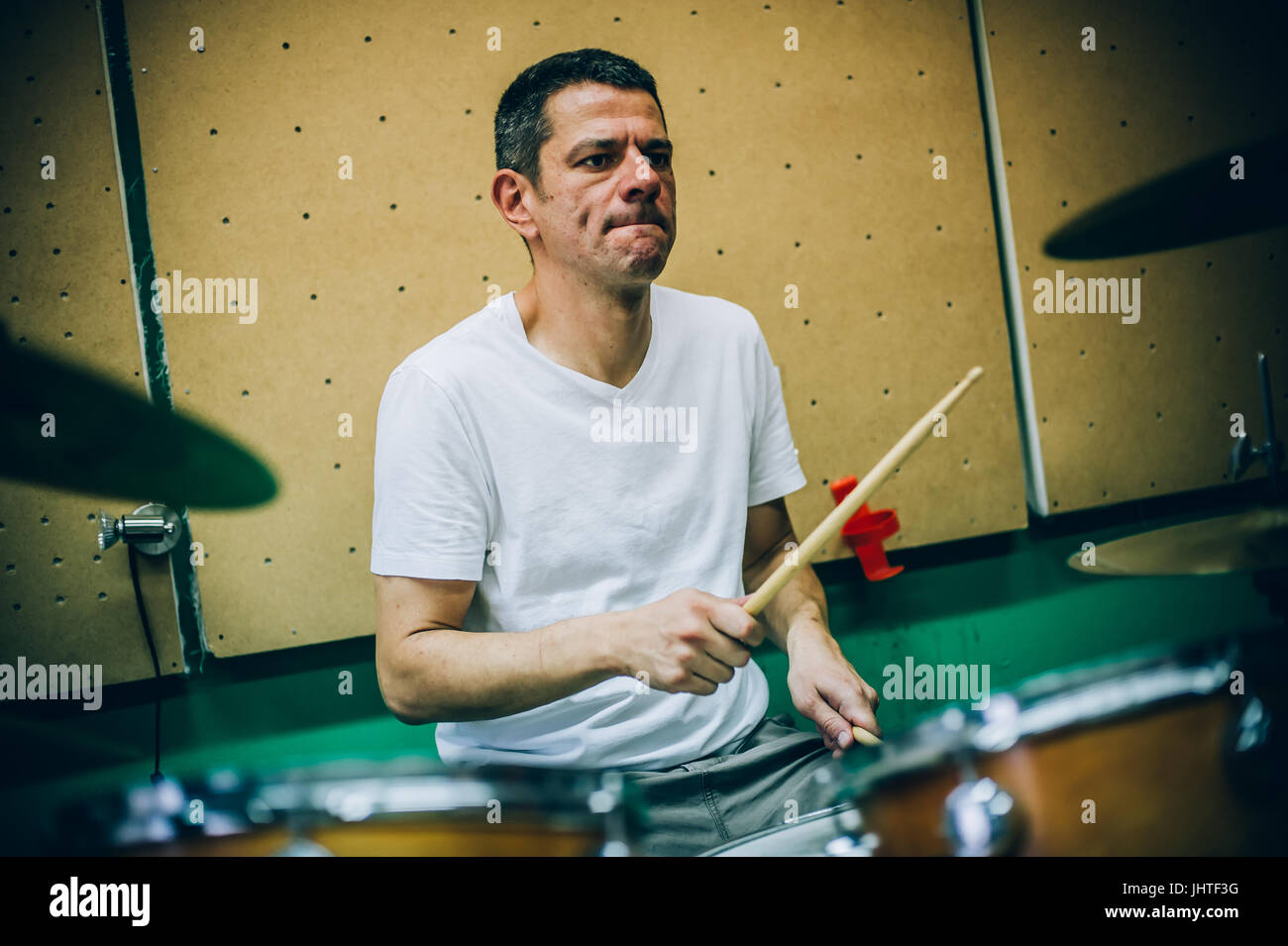 Behind the scene. Male drummer artist musician playing the drums with ...