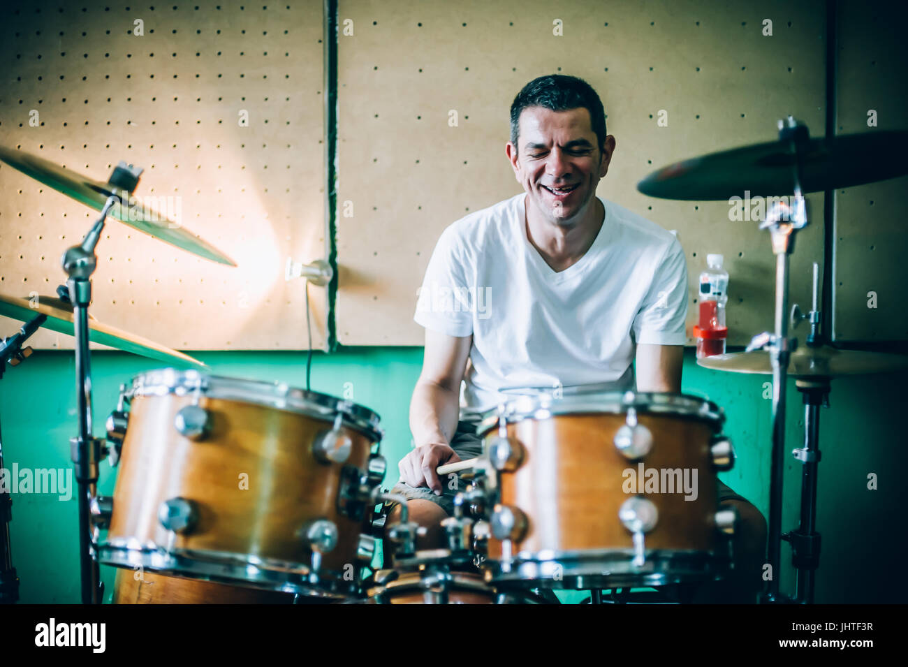 Behind the scene. Male drummer artist musician playing the drums with ...