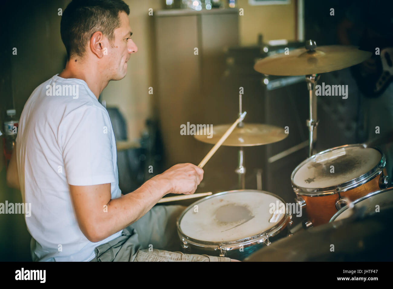 Behind the scene. Male drummer artist musician playing the drums with ...