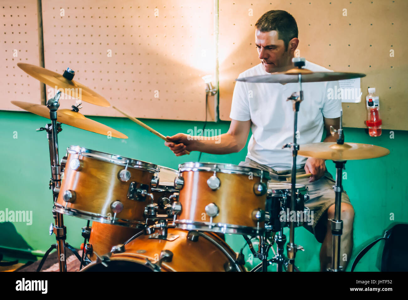 Behind the scene. Male drummer artist musician playing the drums with ...