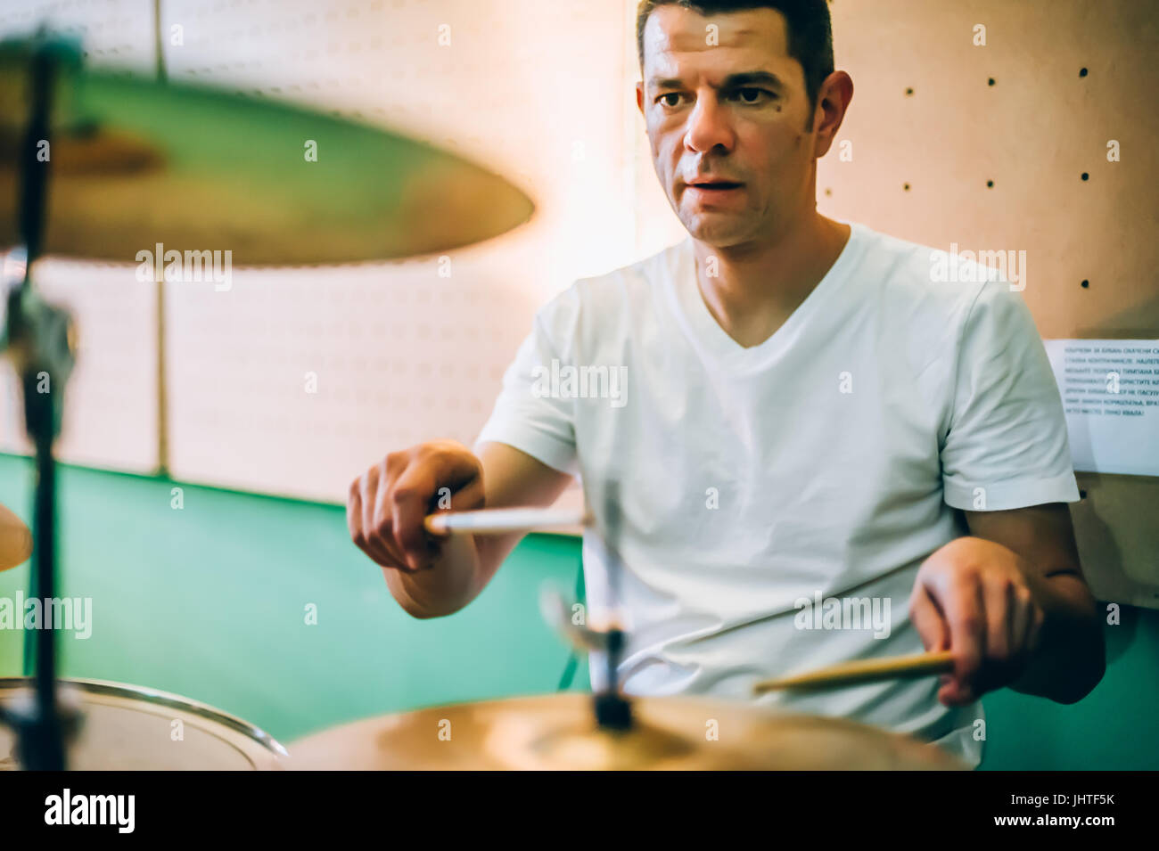 Behind the scene. Male drummer artist musician playing the drums with ...