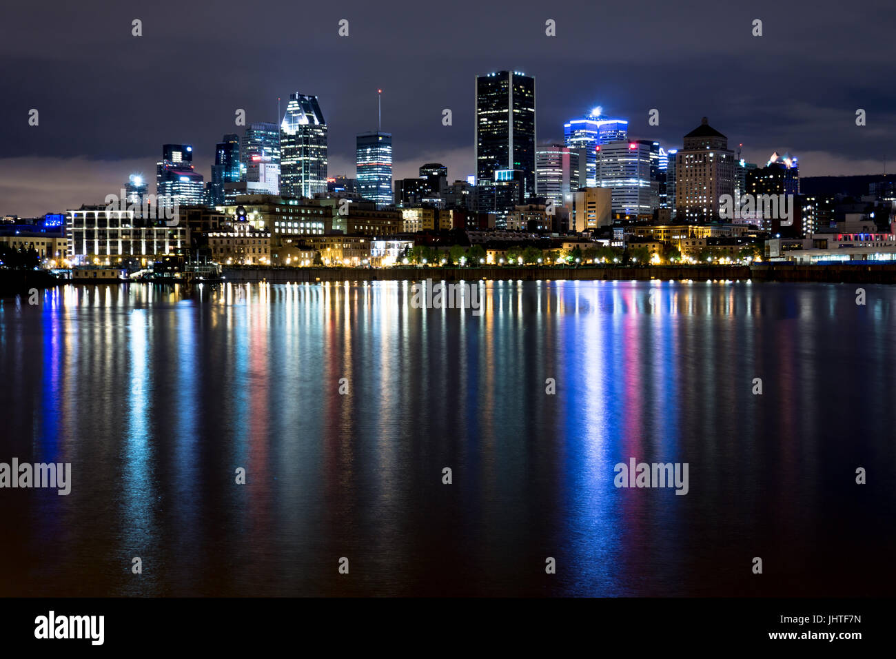 View of the Montreal skyline at night with the reflection of the city ...