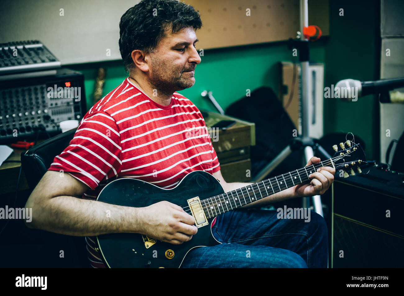 Behind the scene. Male guitarist artist musician practice playing ...