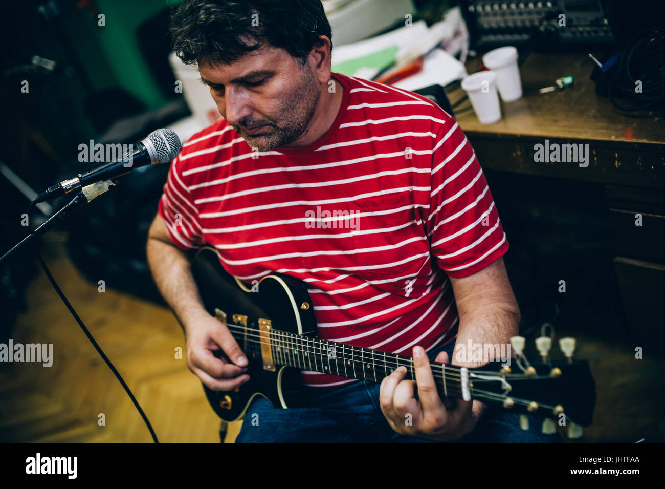 Behind the scene. Male guitarist artist musician practice playing ...