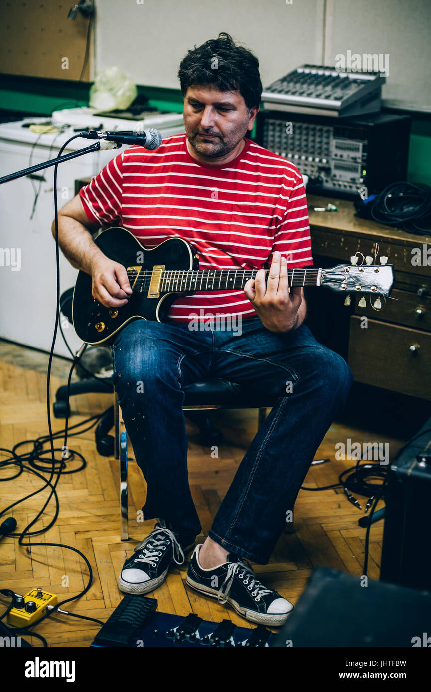 Behind the scene. Male guitarist artist musician practice playing ...