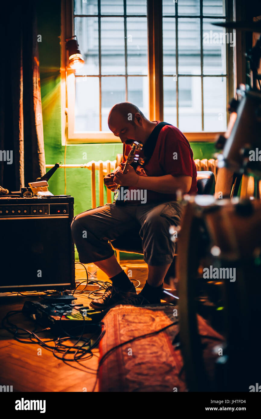 Behind the scene. Male guitarist artist musician practice playing ...