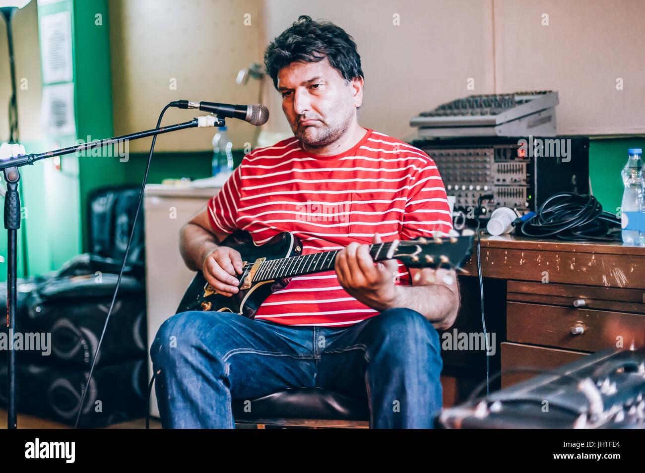 Behind the scene. Male guitarist artist musician practice playing ...