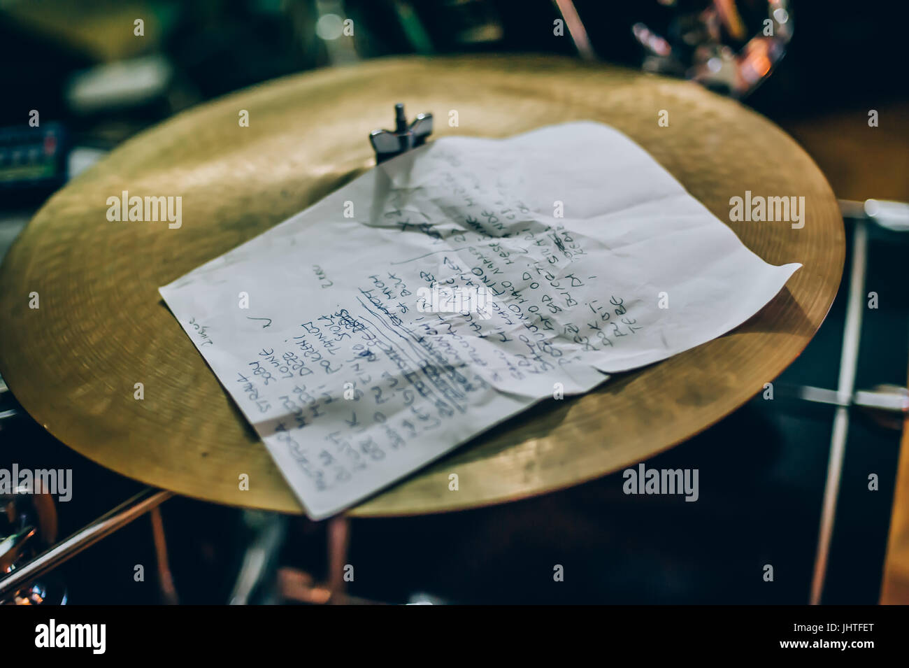 Closeup of lyrics paper with a song text lying on drum set. Musician ...