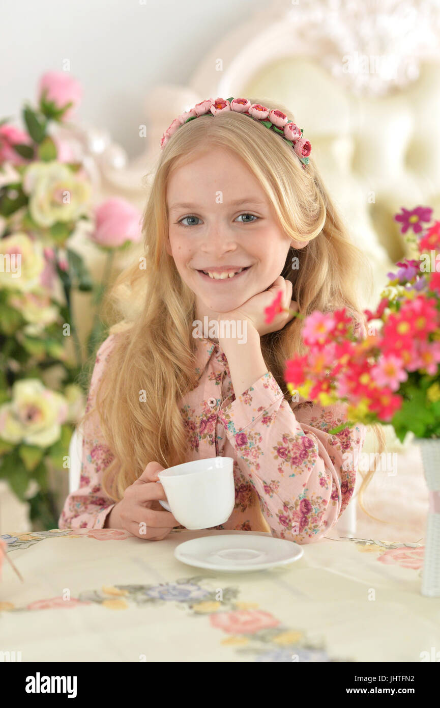 Cute girl drinking tea Stock Photo - Alamy