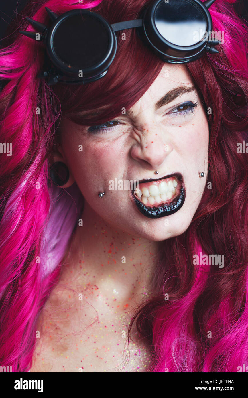 Young woman with pink hair and steampunk look Stock Photo - Alamy